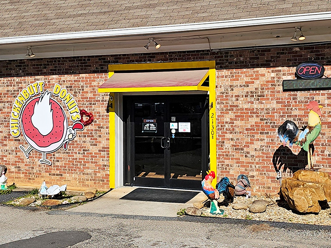 Those colorful roosters guarding the entrance aren't just decoration - they're the unofficial taste-testers at Chickenbutt Donuts!