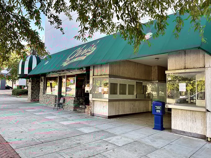 The green awning of Chris' stands guard over Montgomery's hot dog legacy, a culinary landmark that's outlasted countless food trends.