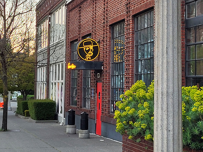 Industrial chic meets culinary fire – behind this brick-and-neon facade, sizzling steaks and timeless indulgence await.