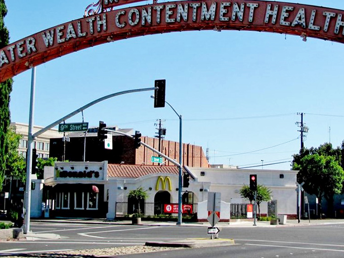 Modesto's iconic "Greater Wealth Contentment Health" arch welcomes visitors to a downtown where retirement dollars stretch further than coastal cities.