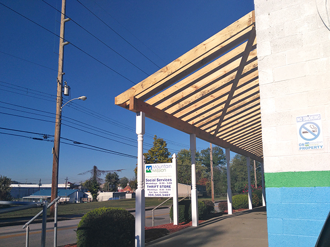Under this wooden awning, treasures await! Mountain Mission's entrance promises affordable finds that help the community.