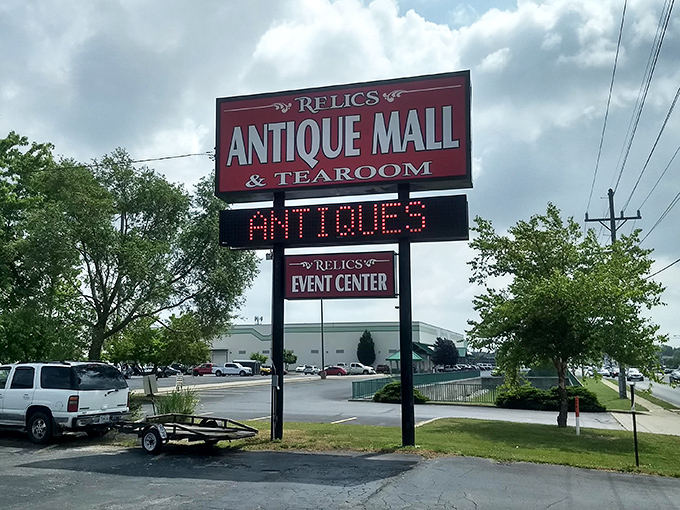 The bold red sign for Relics Antique Mall & Tearoom beckons collectors with a promise: "Come for the antiques, stay for the tea!"