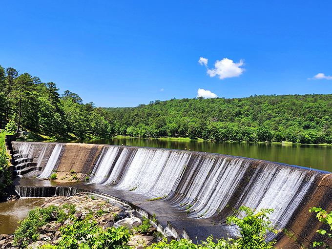 This spillway creates nature's own staircase, where water dances down like champagne at a celebration.