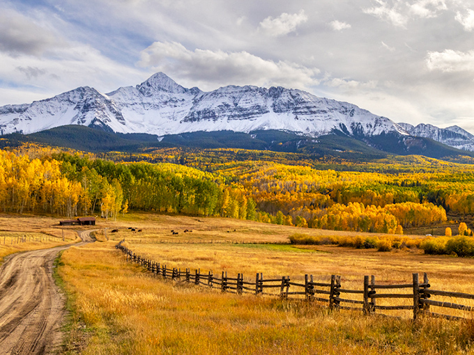 This mountain paradise spreads below like nature's own masterpiece, painted in autumn's finest colors.