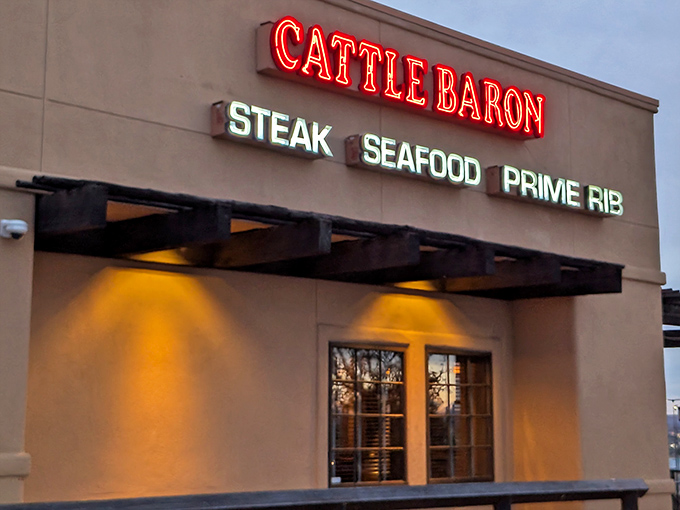 The Cattle Baron's warm evening lights signal that dinner magic is about to happen inside these welcoming walls.