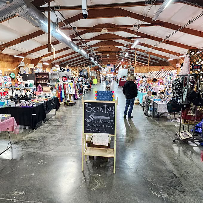 Cathedral-like ceilings watch over vendor booths where Scentsy meets nostalgia in climate-controlled comfort.