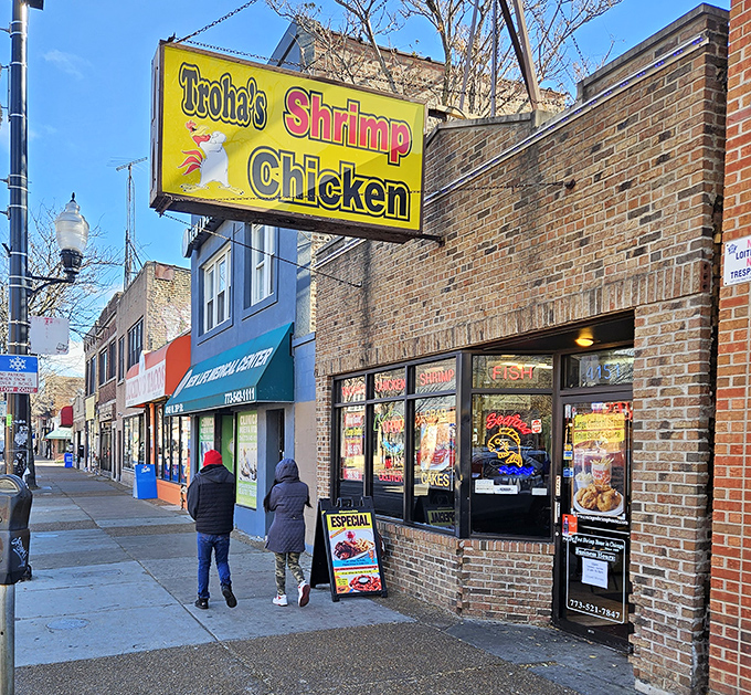Brick building, neon lights, and the promise of crispy goodness—this is neighborhood dining at its finest.