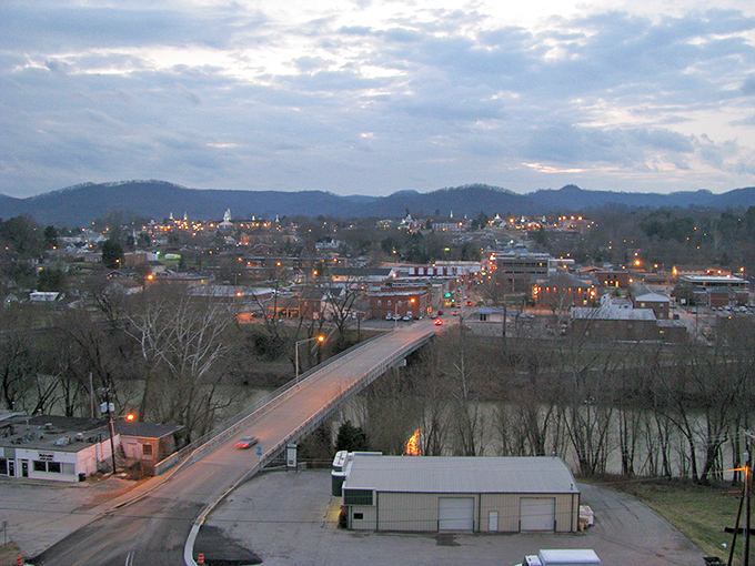 Twilight tranquility! As dusk settles over Williamsburg, the illuminated bridge stretches across the river valley like a string of pearls connecting the town's twinkling lights to the shadowy mountains.