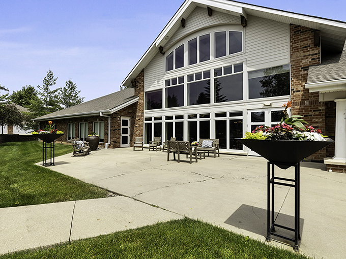 The patio at Woodlands Creek offers a sun-drenched retreat where conversations flow as freely as the Iowa breeze.