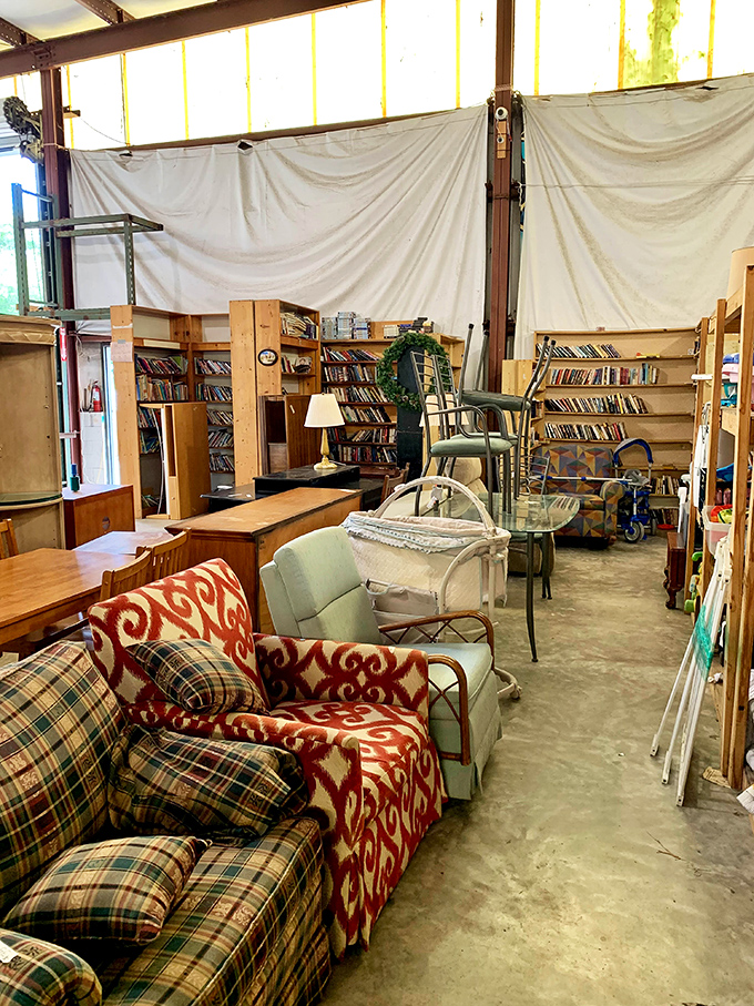 Furniture that tells stories sits patiently waiting for its second chapter. That plaid sofa has probably seen more Florida sunsets than most tourists.