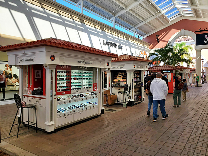 Inside the mall, kiosks and specialty shops create a marketplace atmosphere where sunglasses and souvenirs tempt between major stores.