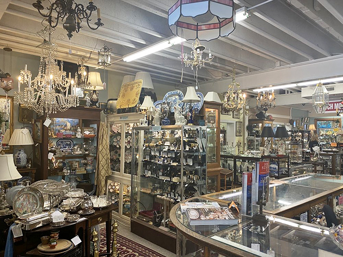 Crystal chandeliers hang like elegant stalactites in this cave of wonders, where light dances across silver serving pieces and delicate glassware.