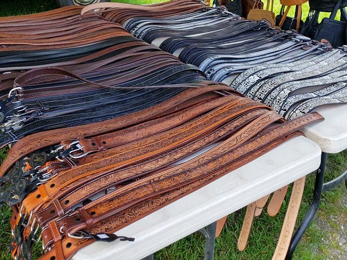 Leather belts cascade across tables in earth tones, proving that quality craftsmanship never goes out of style or breaks.