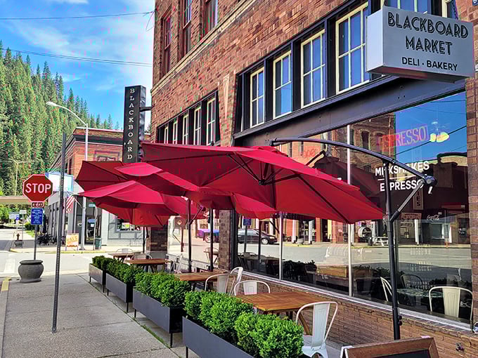 The Blackboard Caf&eacute;'s crimson umbrellas beckon like old friends, promising huckleberry pancakes and local gossip served with equal enthusiasm under the watchful gaze of pine-covered hills.