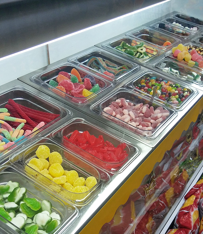 A rainbow of sugar temptations arranged with military precision&mdash;each colorful bin a different path to childhood nostalgia.
