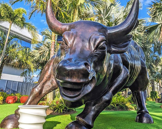 This gleaming bronze bull doesn't just stand there—it practically snorts with life, its expression somehow both intimidating and oddly cheerful.