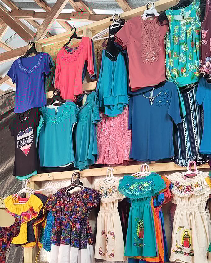 A rainbow of fabrics tells stories through clothing—each vibrant Mexican dress and embroidered blouse waiting for its next chapter.