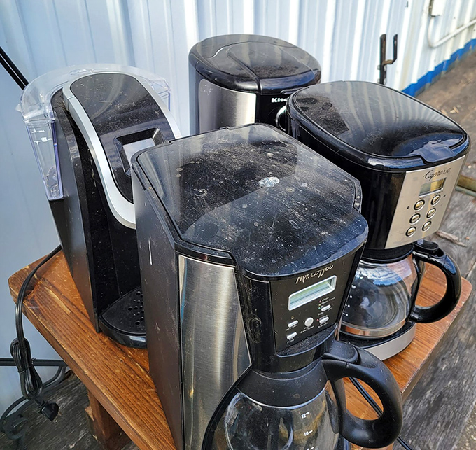 The coffee maker graveyard, where yesterday's brewing technology awaits resurrection. One person's caffeine contraption castoff becomes another's morning salvation.