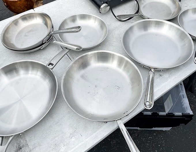 Professional-grade cookware awaits its next kitchen adventure. These well-built pans have likely flipped more pancakes than IHOP on a Sunday morning.