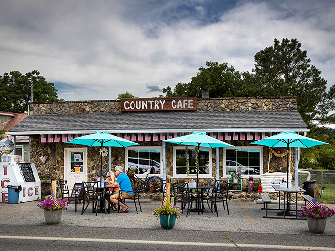 The Country Caf&eacute;'s stone exterior promises comfort food that hugs your insides, while those turquoise umbrellas beckon like old friends on a sunny day.