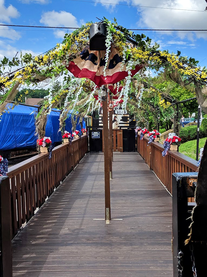 Not just any walkway&mdash;a portal to adventure adorned with patriotic flair and floral touches. The red, white, and bloom welcome committee.