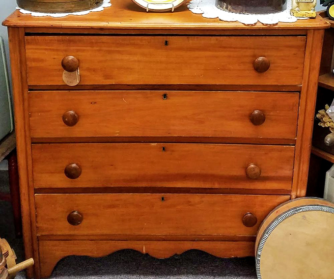 This honey-toned dresser has likely witnessed morning routines from multiple generations. Solid craftsmanship that puts today's particle board furniture to shame.