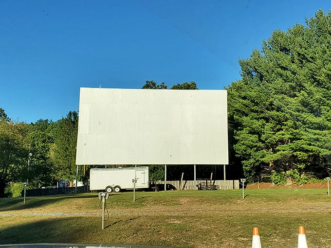 Standing tall against the blue sky, the massive white screen awaits dusk's embrace. Like a blank canvas ready for Hollywood's brushstrokes.