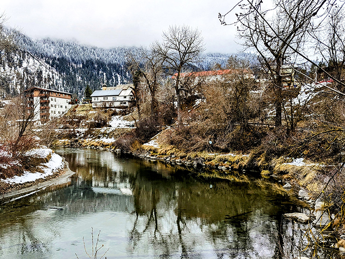 The Wenatchee River reflects snow-dusted mountains and riverside buildings, creating nature's perfect mirror that Instagram filters couldn't improve if they tried.