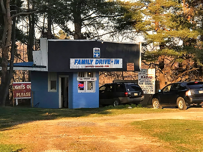 "Lights Out Please" signs remind us of drive-in etiquette, a gentle throwback to a more considerate entertainment era.