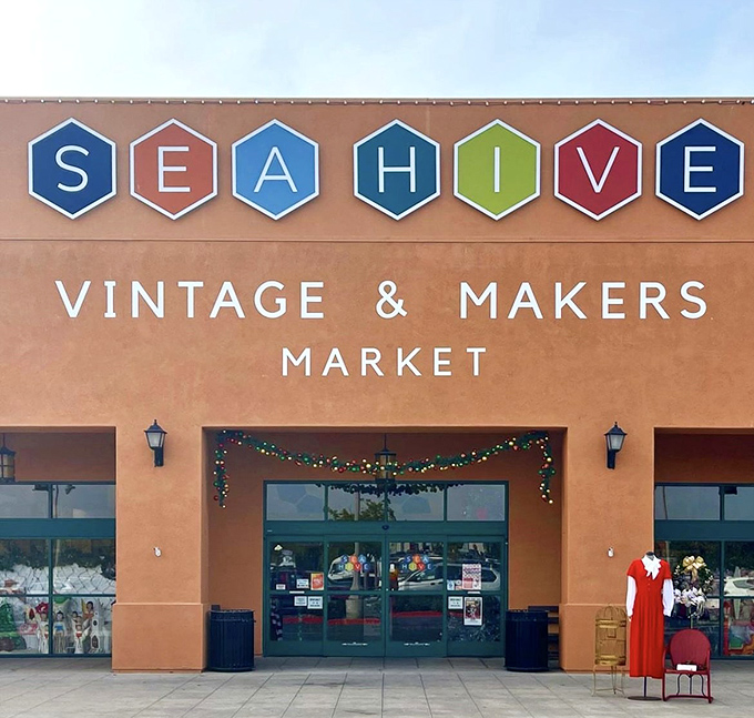 Holiday lights frame the entrance, while a bold red vintage dress stands sentinel, teasing the wonders waiting inside.