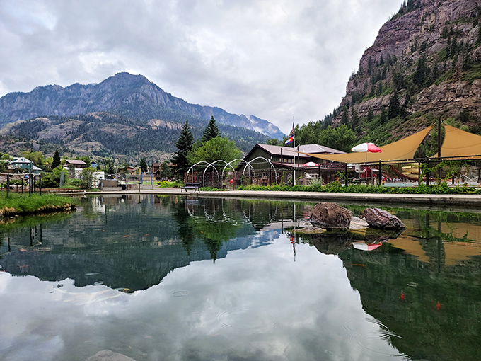 Fellin Park's reflecting pool mirrors the surrounding peaks, creating twice the beauty with half the effort. Nature showing off its Photoshop skills.