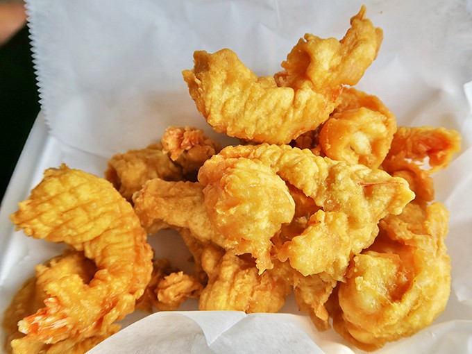 Golden-battered shrimp that crunch like nature's perfect potato chip before giving way to that sweet, succulent interior. Worth every mile of the drive.