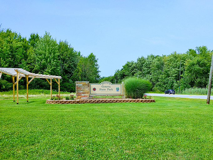 Geneva State Park's entrance promises adventure without the theme park prices. Nature's version of an all-inclusive resort, minus the pushy towel attendants.