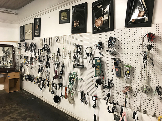 The wall of technological possibility – where yesterday's gadgets and today's necessities hang in a tangle of potential and nostalgia.
