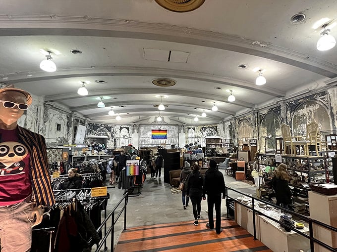 The grand, arched ceiling and rainbow flag hint at both the building's historic past and its meaningful present-day mission.