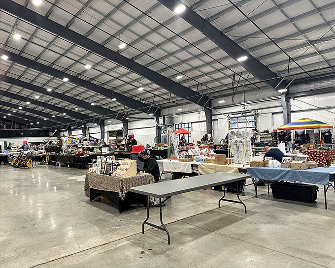 Under industrial ceilings, vendors arrange their wares with care. This cavernous space transforms into a marketplace where stories and objects find new homes.