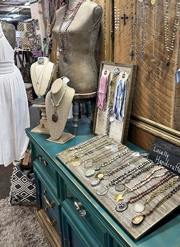 Treasure hunters rejoice! Each handcrafted necklace and vintage brooch carries stories from another era, displayed on a beautifully upcycled teal dresser.