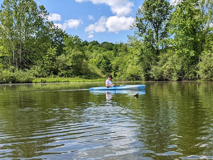 Social media can wait when you're paddling through serenity. This kayaker has traded digital notifications for nature's soundtrack.