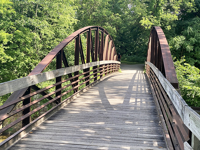 This wooden bridge along the towpath isn't just crossing water &ndash; it's spanning centuries, connecting modern hikers to the ghosts of canal workers who built this region.