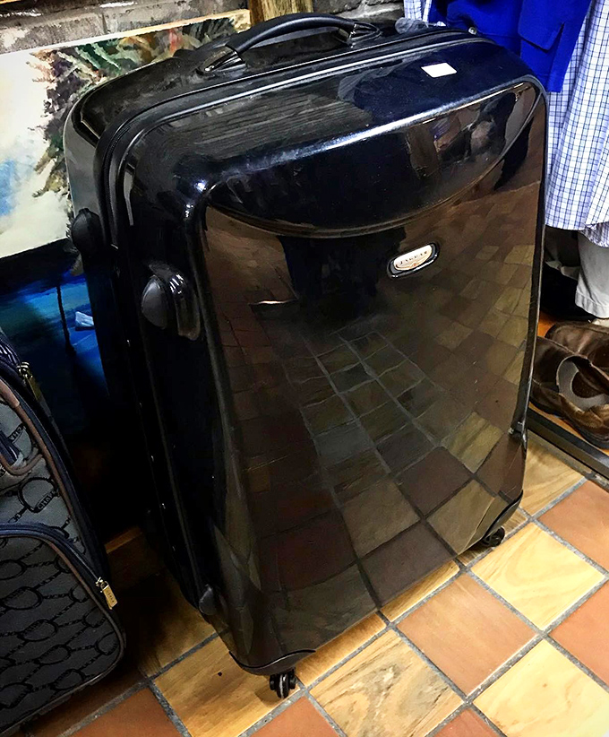 This sleek black suitcase has stories to tell. For under $20, your luggage can have more passport stamps than your own.