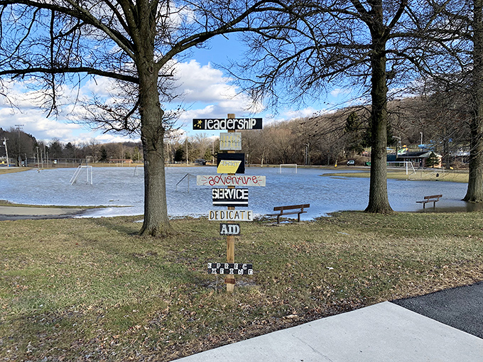 This community signpost at Lynch Field Park reminds us that the best small towns are built on values worth celebrating&mdash;and occasionally getting your shoes muddy for.