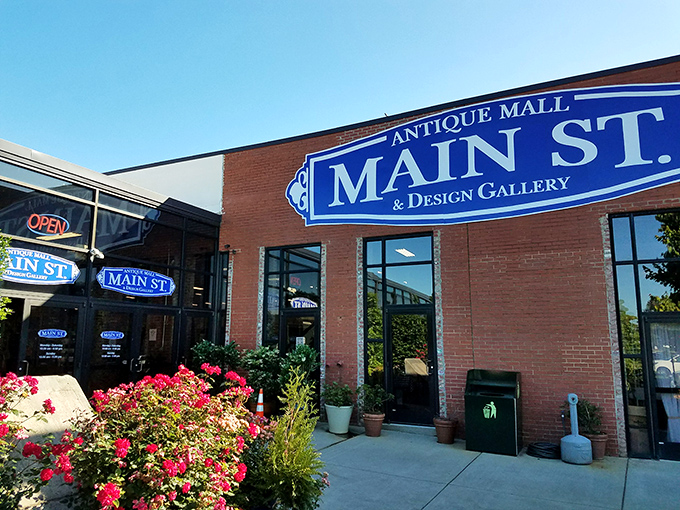 The Main Street Antique Mall welcomes treasure hunters with vibrant flowers and the promise of finding that one perfect thing you never knew you needed.