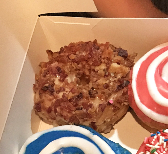 Behold the star attraction: the maple bacon donut, where breakfast's perfect couple finally ties the knot in sweet-savory matrimony.