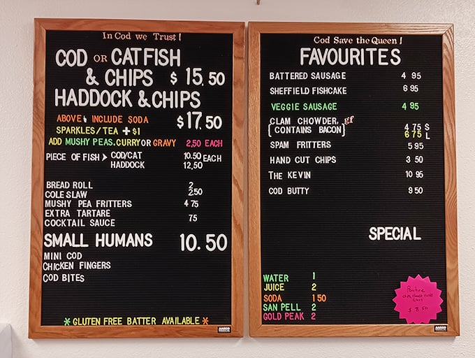 "In Cod We Trust" isn't just clever wordplay&mdash;it's a mission statement. This menu board's "Small Humans" section proves British humor travels well across the pond.