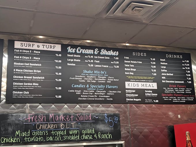 The menu board reads like a love letter to American classics. No molecular gastronomy here, just the timeless poetry of burgers, shakes, and fries.