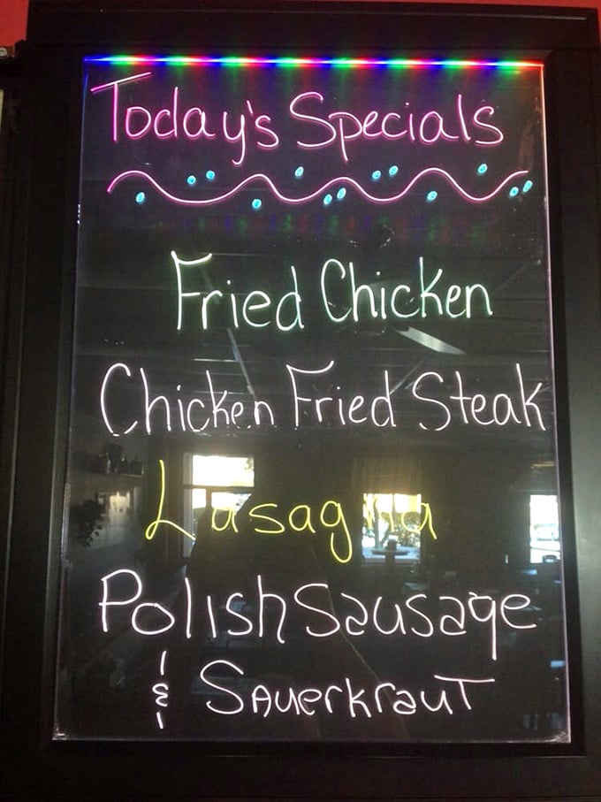 That illuminated specials board is like a neon-lit love letter to comfort food classics. Fried chicken and Polish sausage on the same menu? Heaven exists!