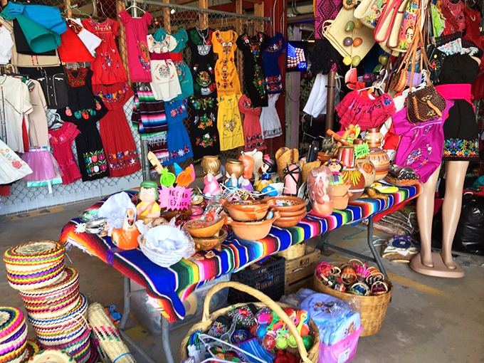 A kaleidoscope of culture hangs from every inch of this stall, where traditional Mexican craftsmanship meets Florida's melting pot marketplace.
