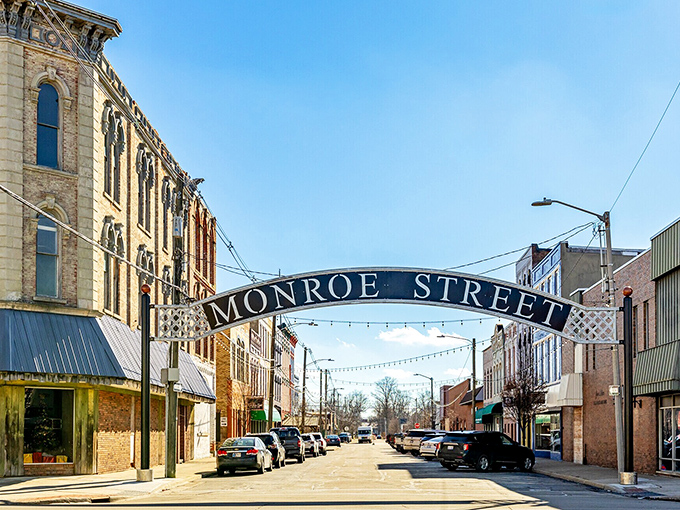 The Monroe Street archway welcomes you to a downtown where shopkeepers still remember your name and your coffee order.