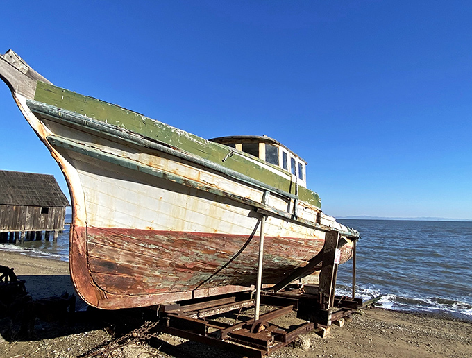 Time and tides have weathered this old fishing boat, now permanently docked in memories, a testament to the Chinese shrimping community that once thrived here.