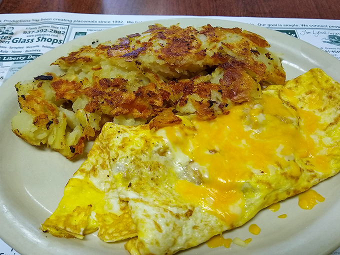 This is breakfast alchemy: perfectly crispy hash browns alongside a cheese omelet that stretches with each heavenly bite. Morning glory on a plate.